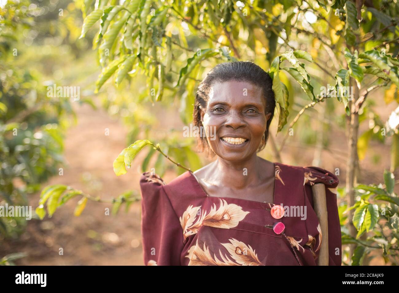 Closeup portrait of a woman wearing a traditional Ugandan gomesi dress ...
