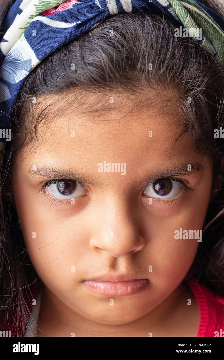 Cute little girl looking seriously Stock Photo - Alamy