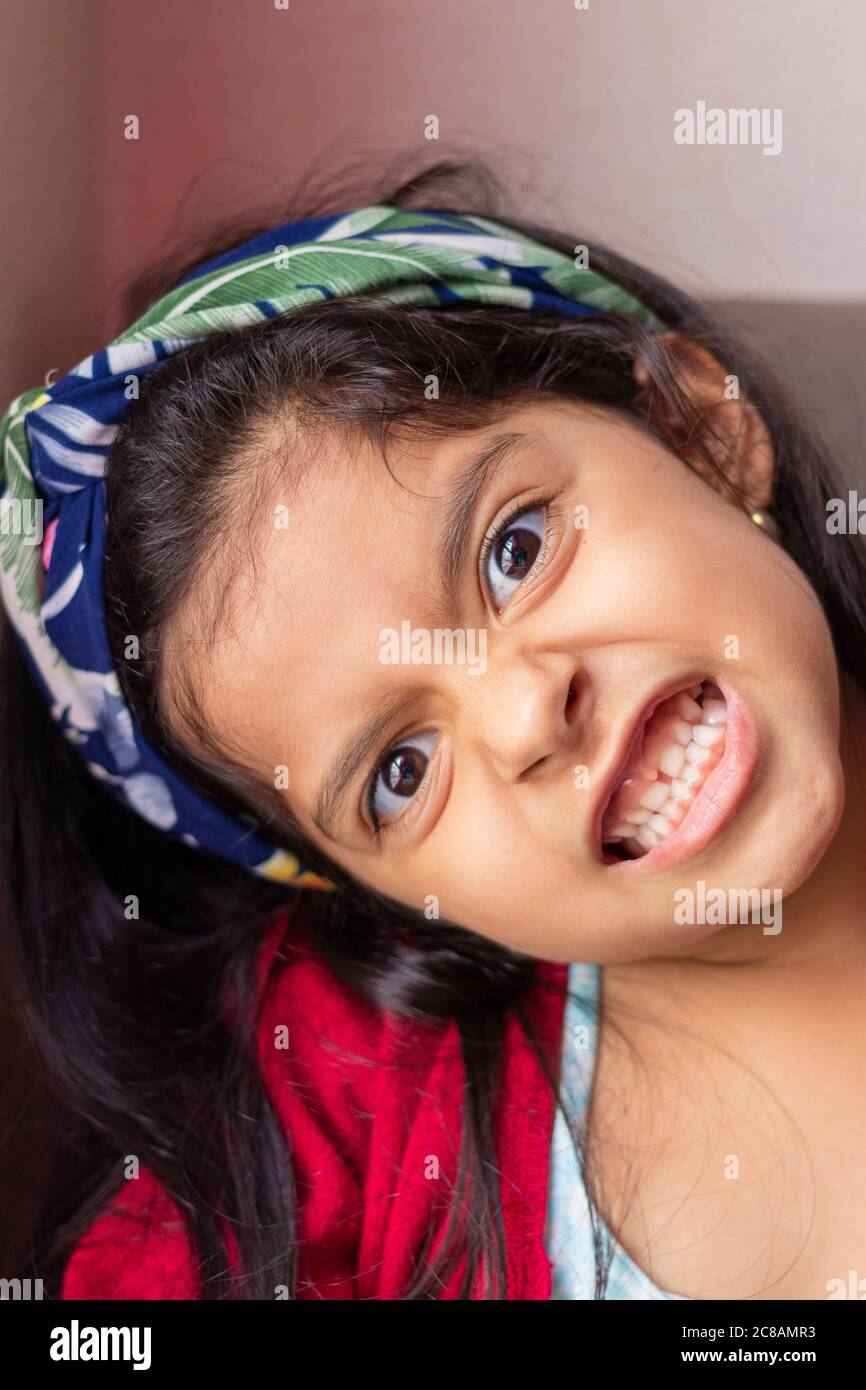 Little mischievous girl showing her funny smile Stock Photo - Alamy