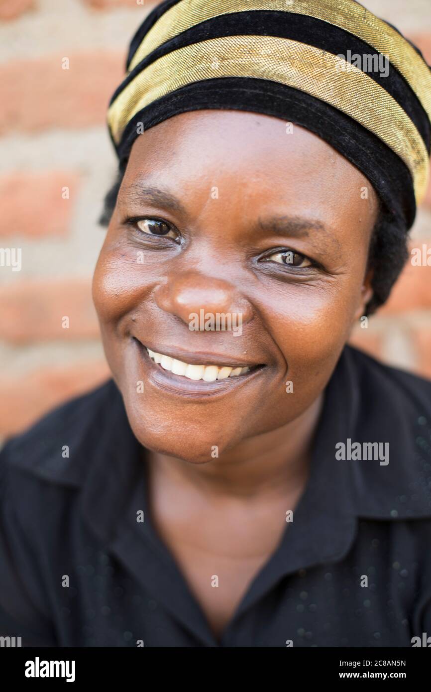 Closeup portrait of a beautiful smiling woman wearing a headwrap in ...