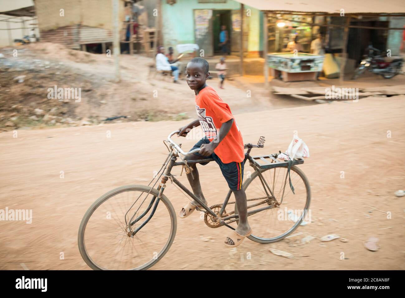 A child rides a bike in Bukomansimbi District, Uganda. LWR Uganda Youth ...