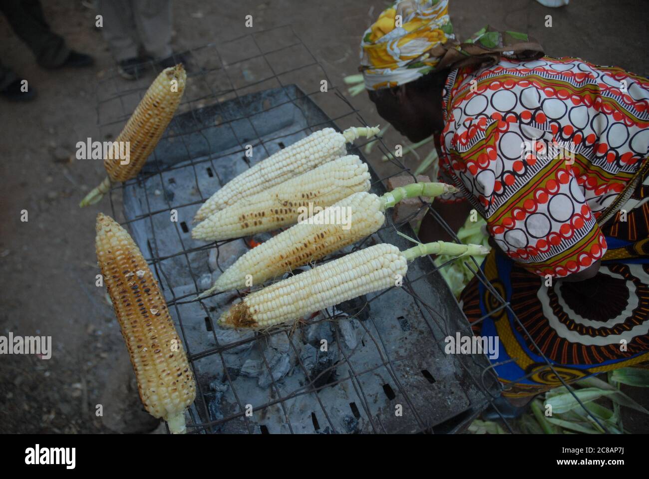 A women selling cooked corn on a grill, Lilongwe, Malawi, Africa Stock ...