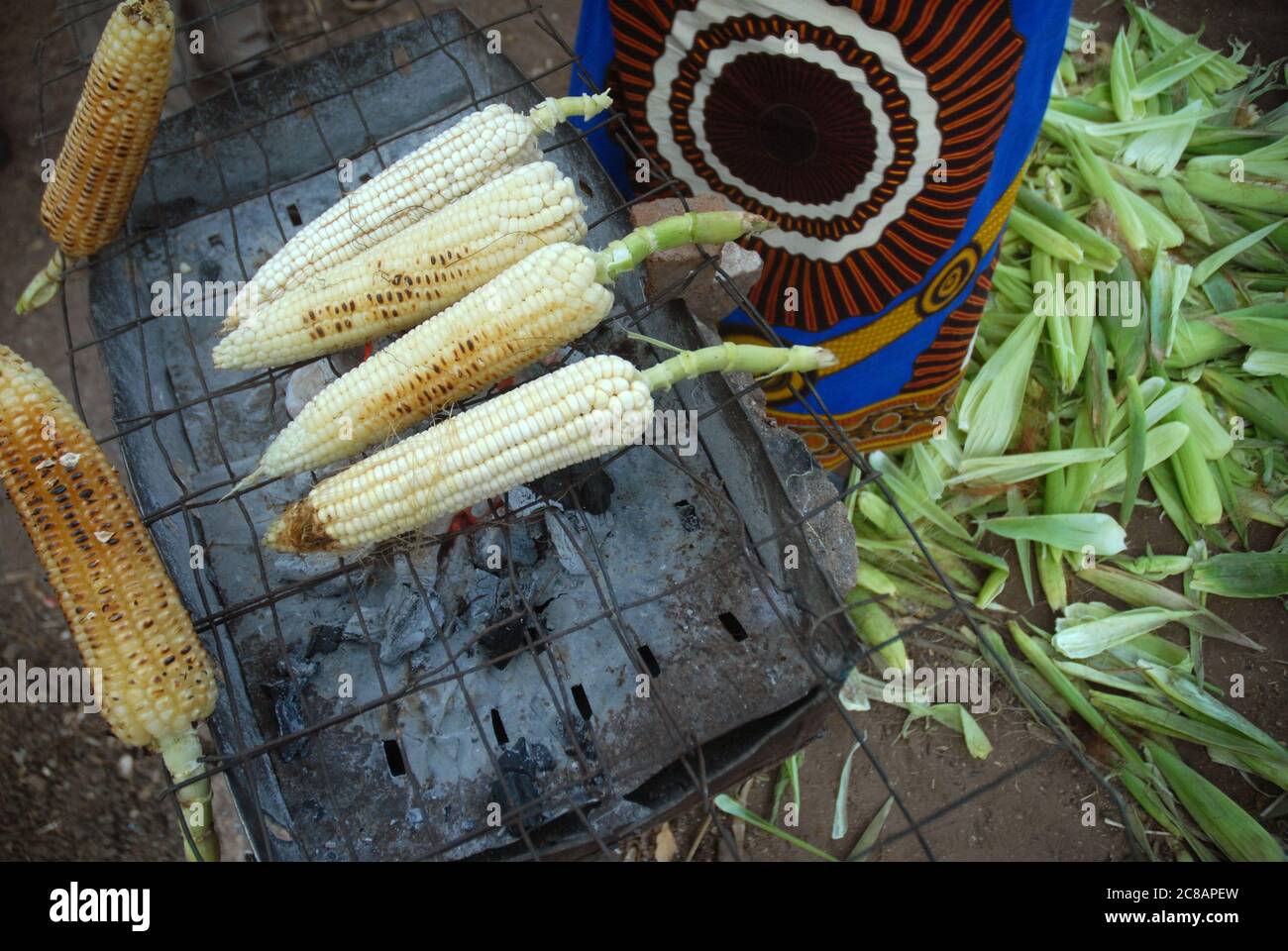 A women selling cooked corn on a grill, Lilongwe, Malawi, Africa Stock ...