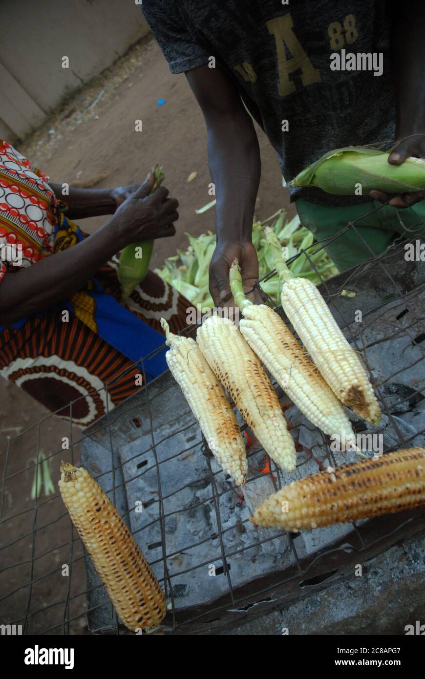 A women selling cooked corn on a grill, Lilongwe, Malawi, Africa Stock ...