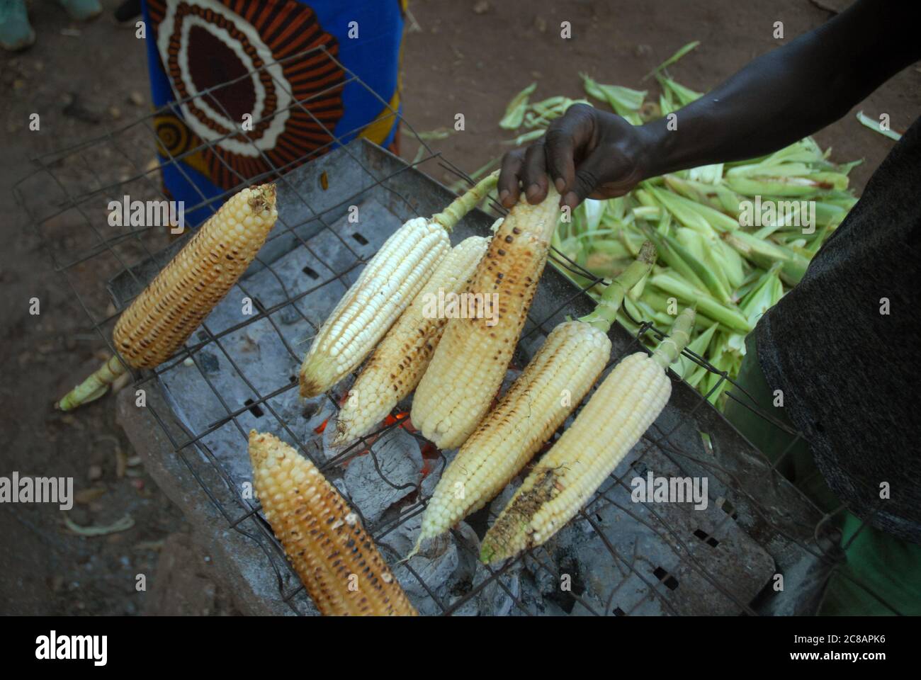 A women selling cooked corn on a grill, Lilongwe, Malawi, Africa Stock ...
