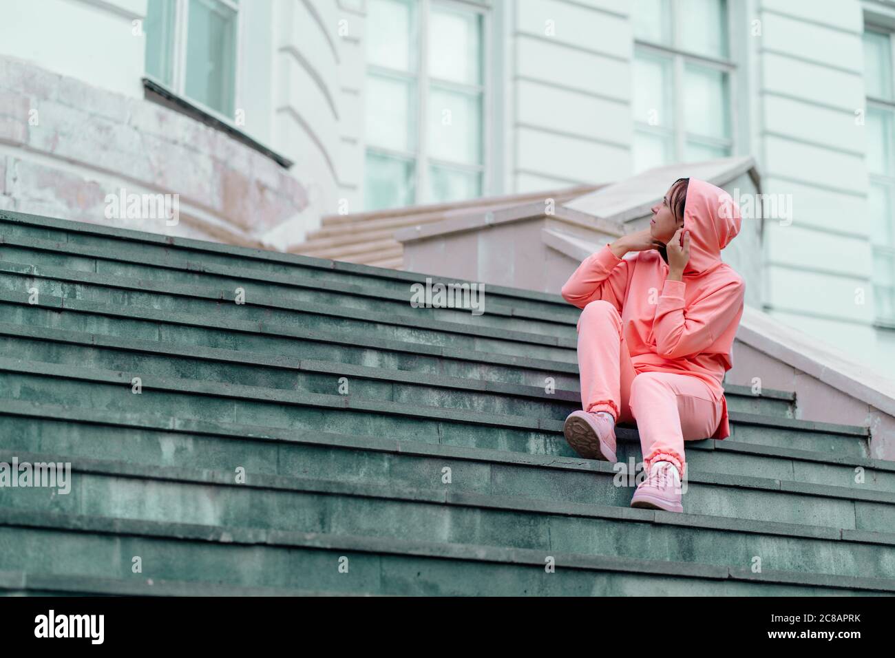 Woman sitting on stair hi-res stock photography and images - Alamy
