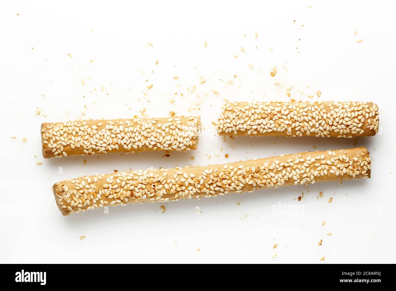 bread sticks with sesame seeds on white Stock Photo - Alamy