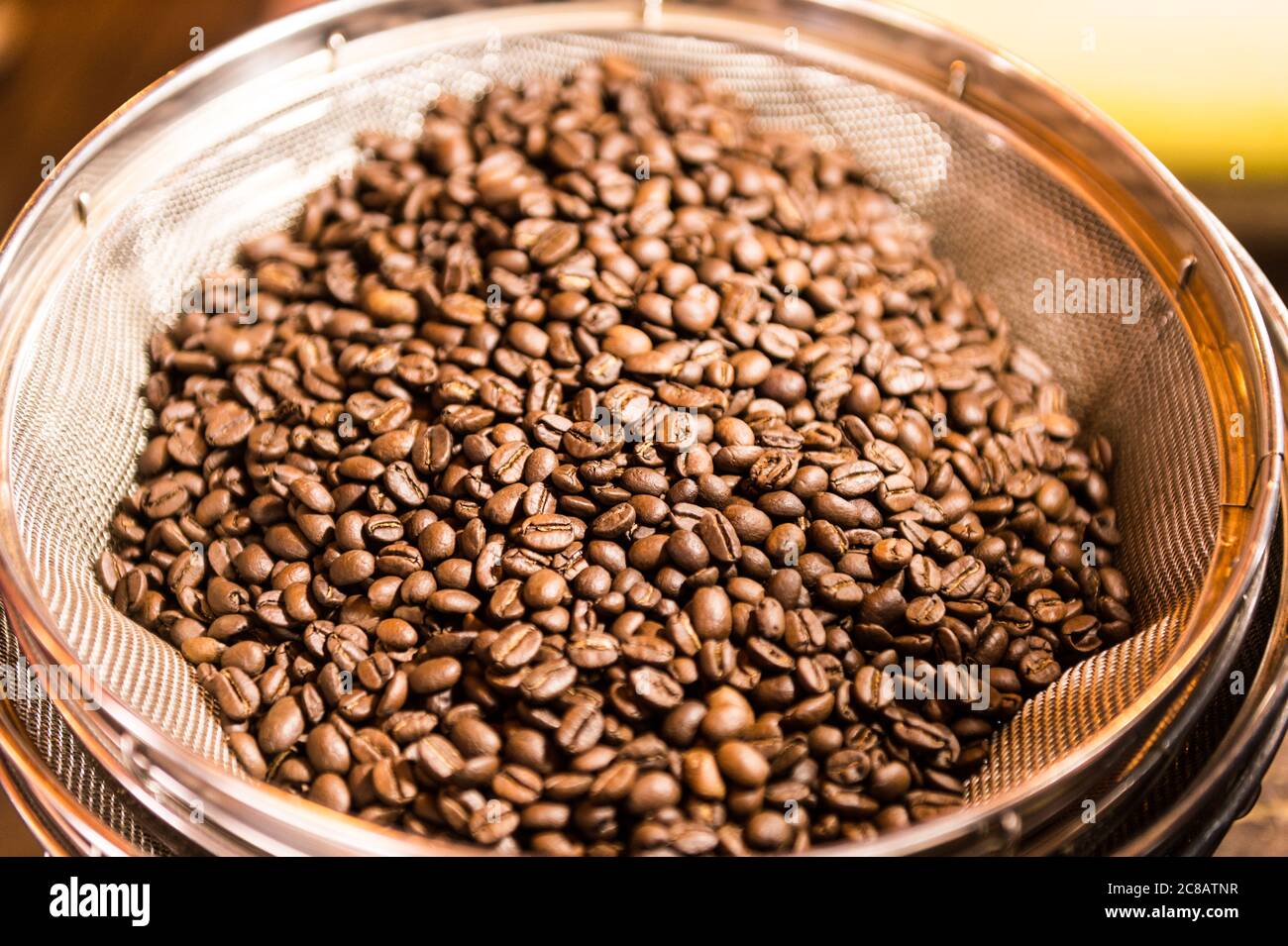 Mixing roasted coffee Stock Photo - Alamy