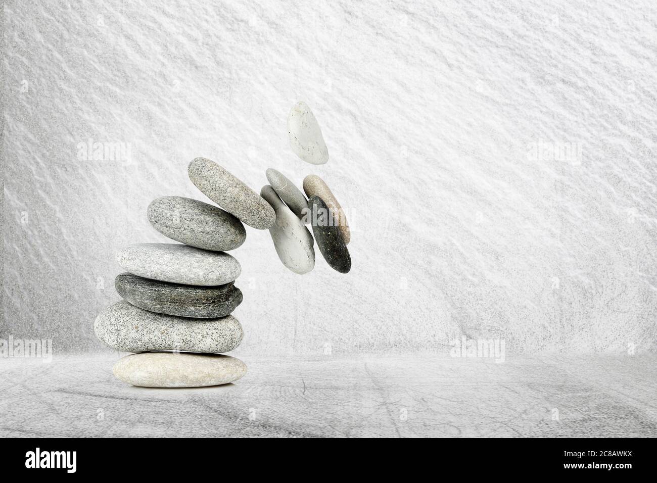 stack of stones while falling apart, abstract concept Stock Photo - Alamy