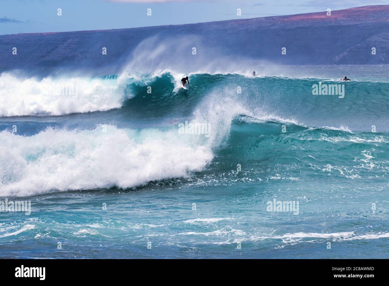 Energetic surfer riding a big wave on the South side of Maui Stock ...