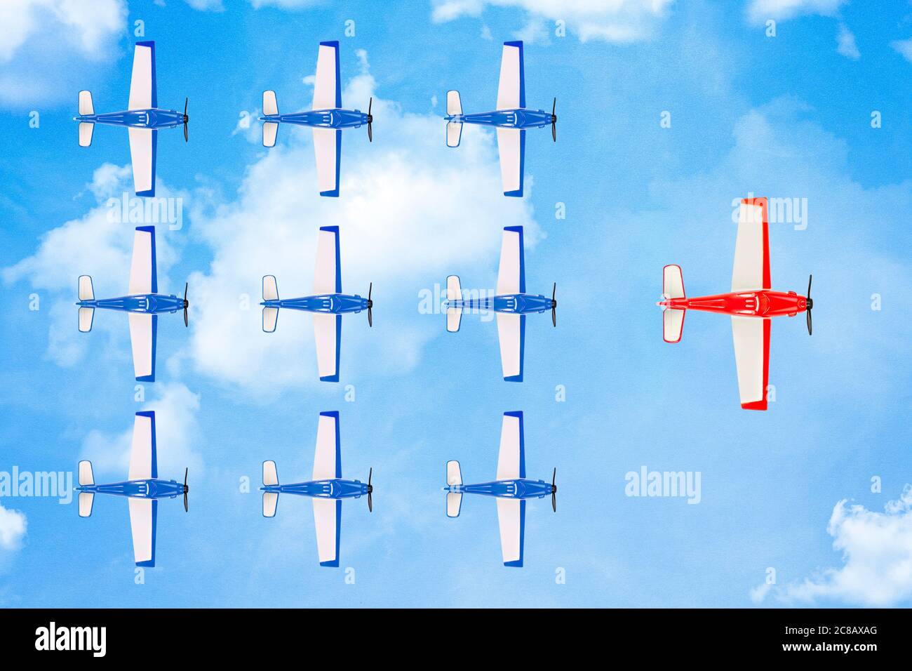 red plane leading a formation of smaller planes on paper surface with ...