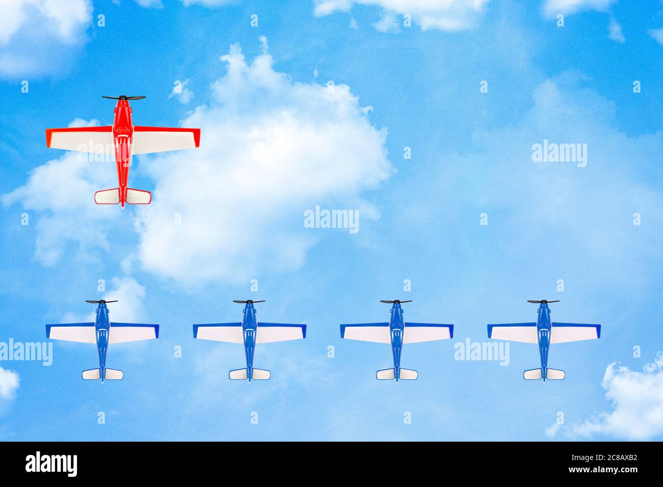 red plane leading a formation of smaller planes on paper surface with ...