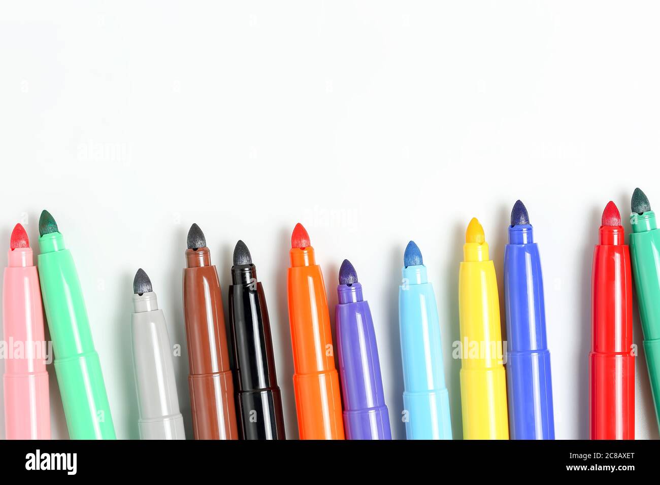 colorful markers closeup on white surface with copy space Stock Photo ...