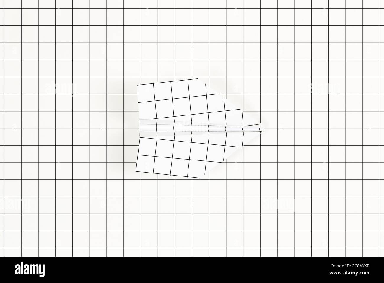 paper plane on white paper surface with squares Stock Photo - Alamy