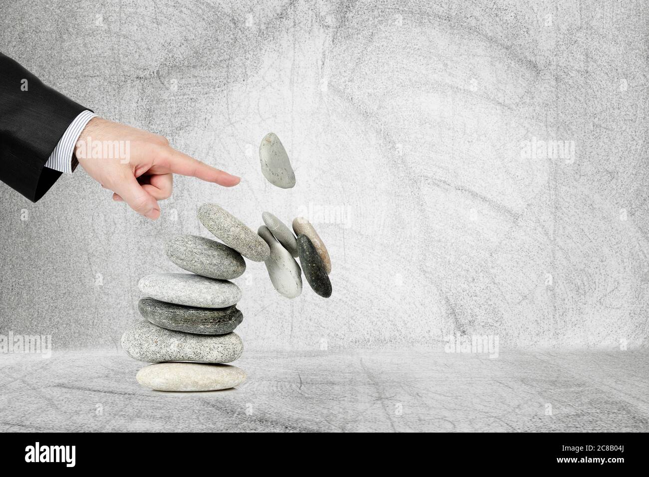 male hand pushing a stack of stones Stock Photo - Alamy