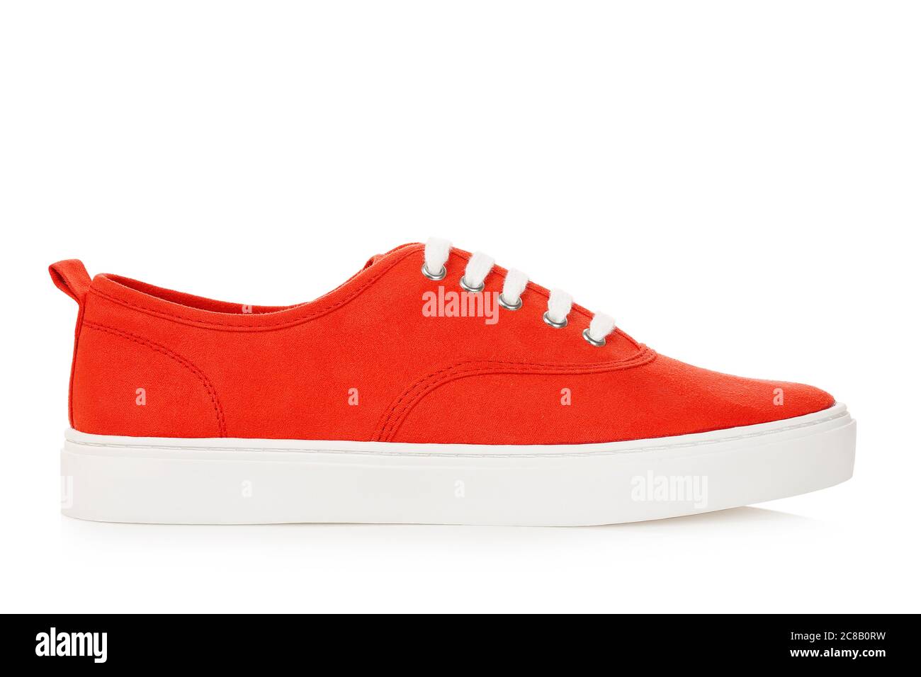 single red suede sneaker isolated on white, side view Stock Photo - Alamy