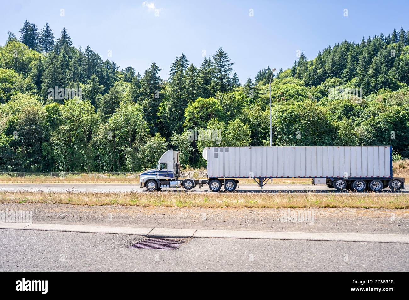Big rig blue shiny industrial diesel day cab powerful semi truck ...