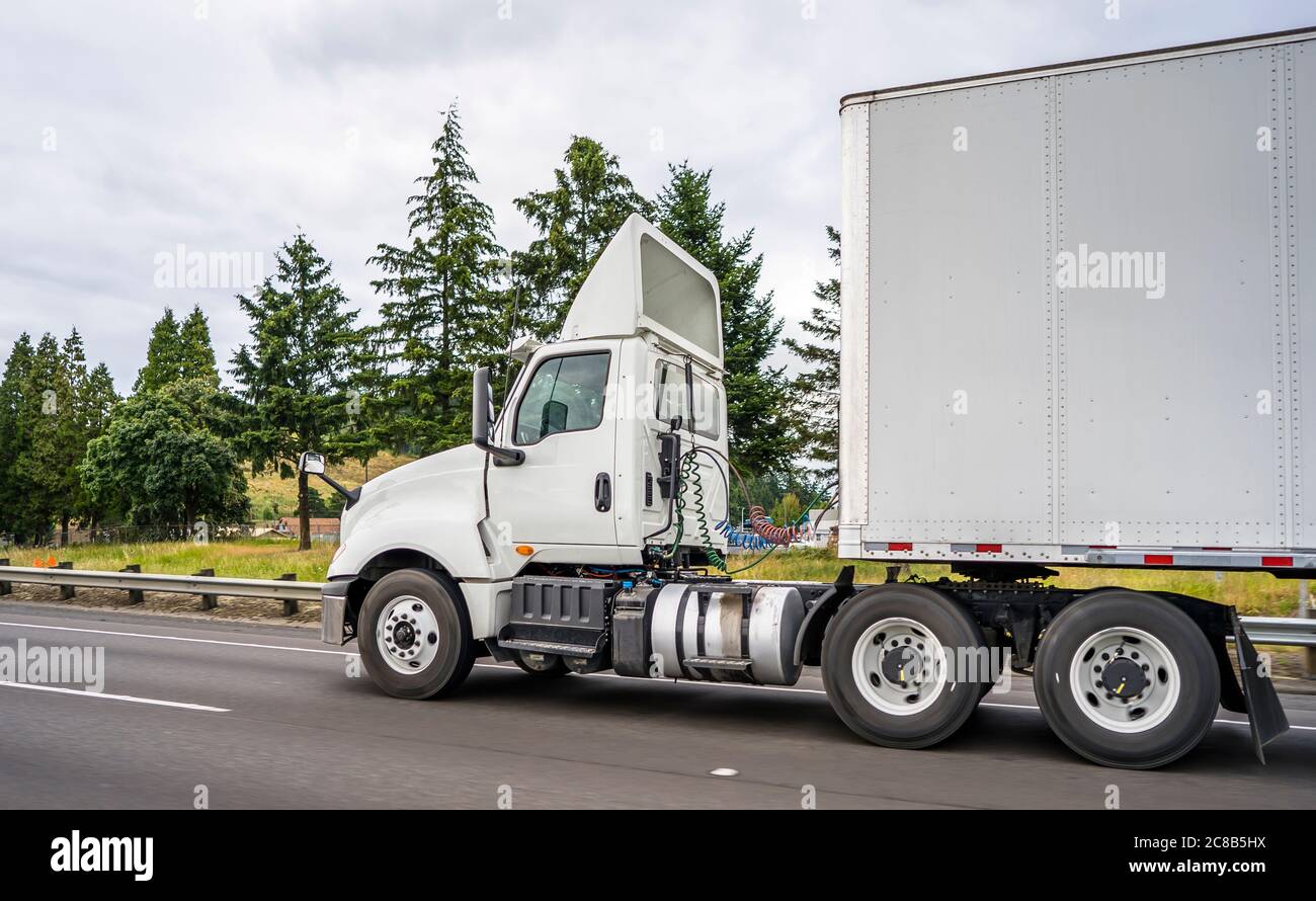 Big rig white industrial diesel day cab semi truck with roof spoiler ...