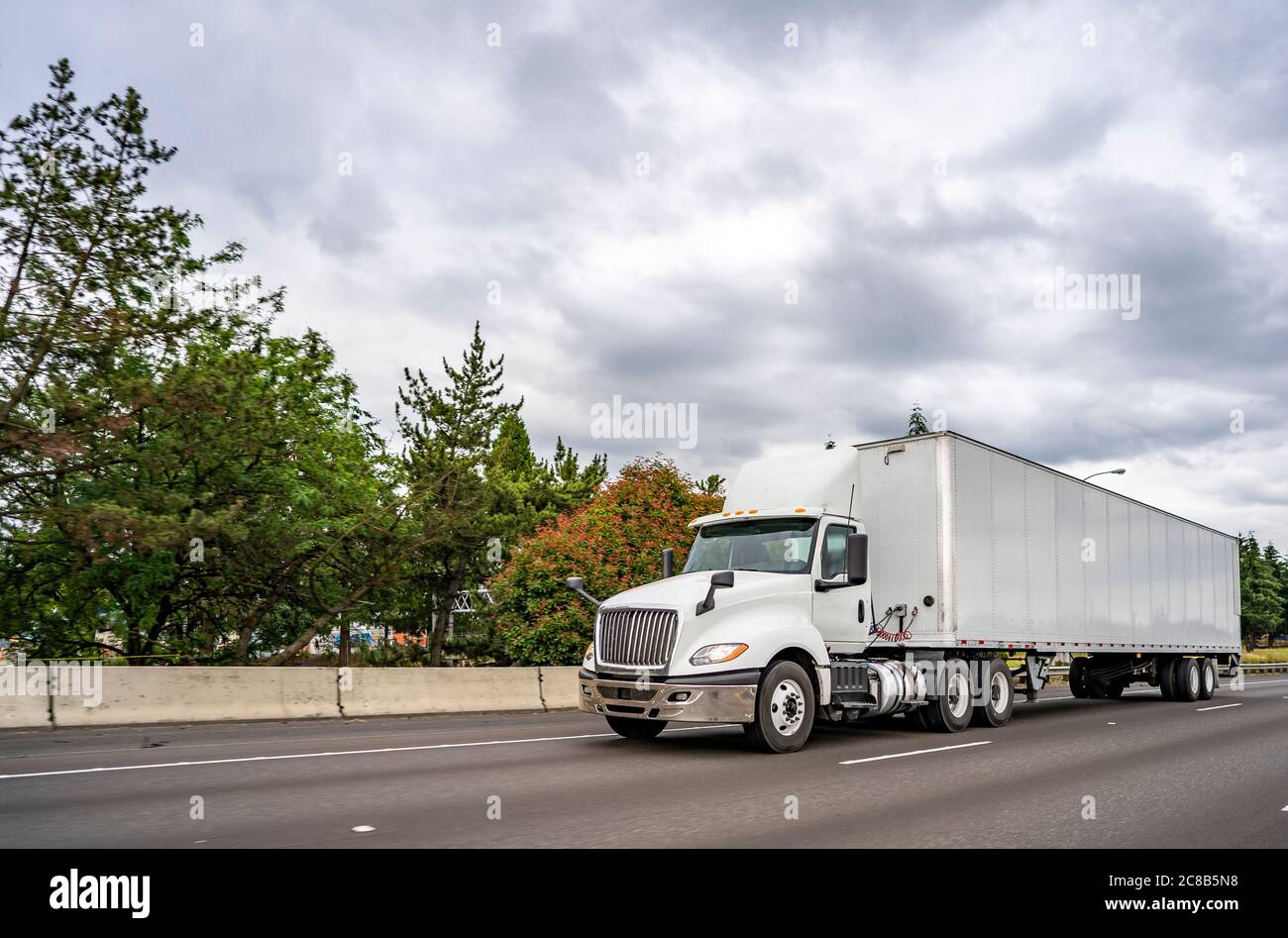 Big rig white industrial diesel day cab semi truck with roof spoiler ...
