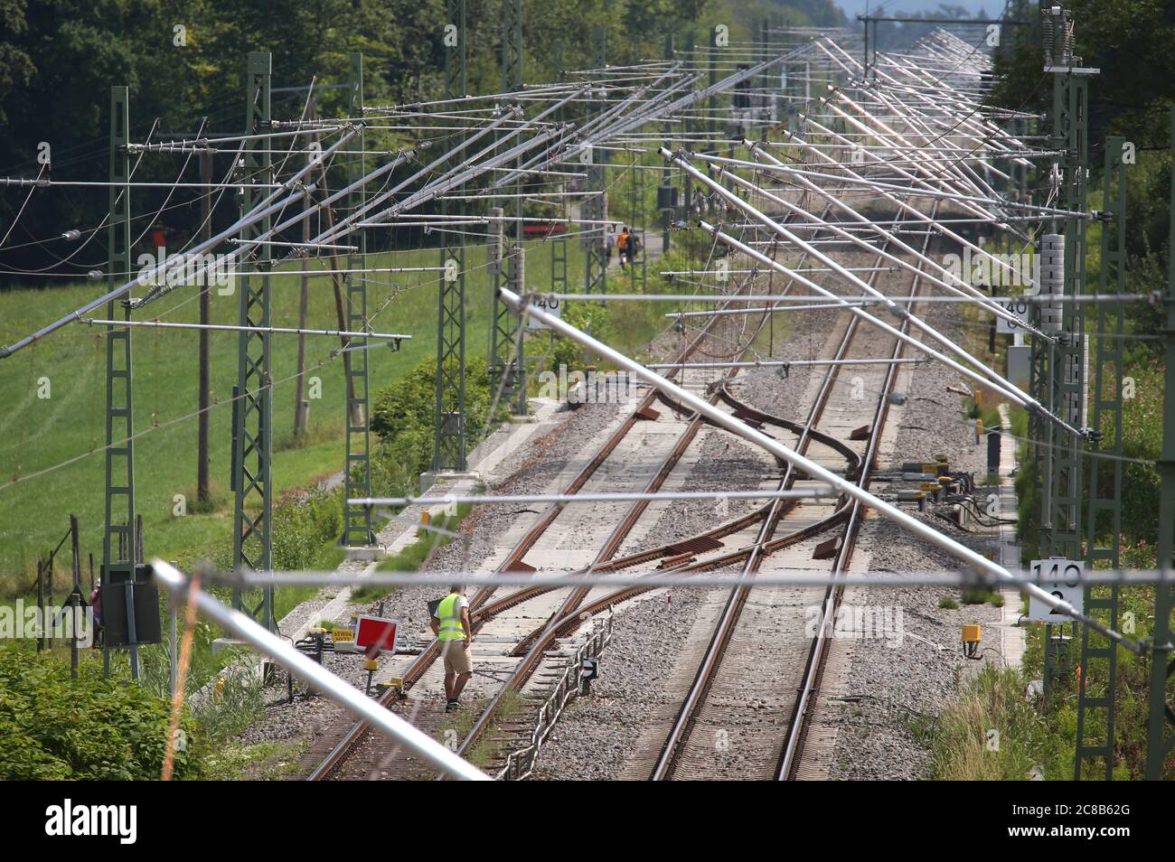 22 July 2020, Bavaria, Weißensberg: A Deutsche Bahn employee stands at ...
