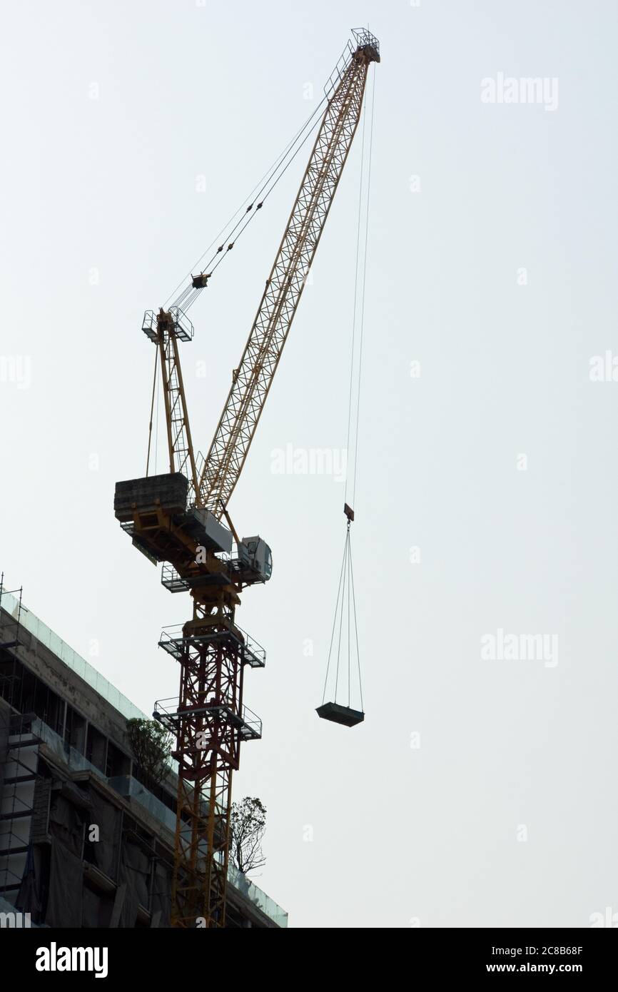 Crane machine lifting materials and crane construction equipment on a ...