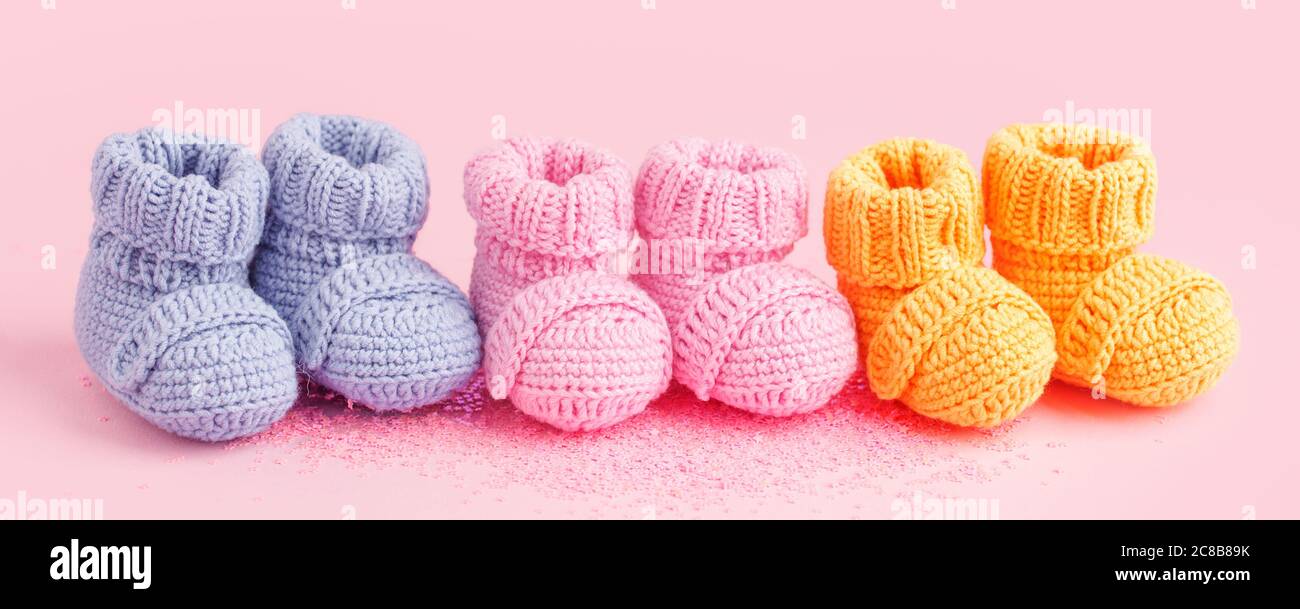 Pregnancy motherhood perenthood concept, Three pairs of baby booties on ...