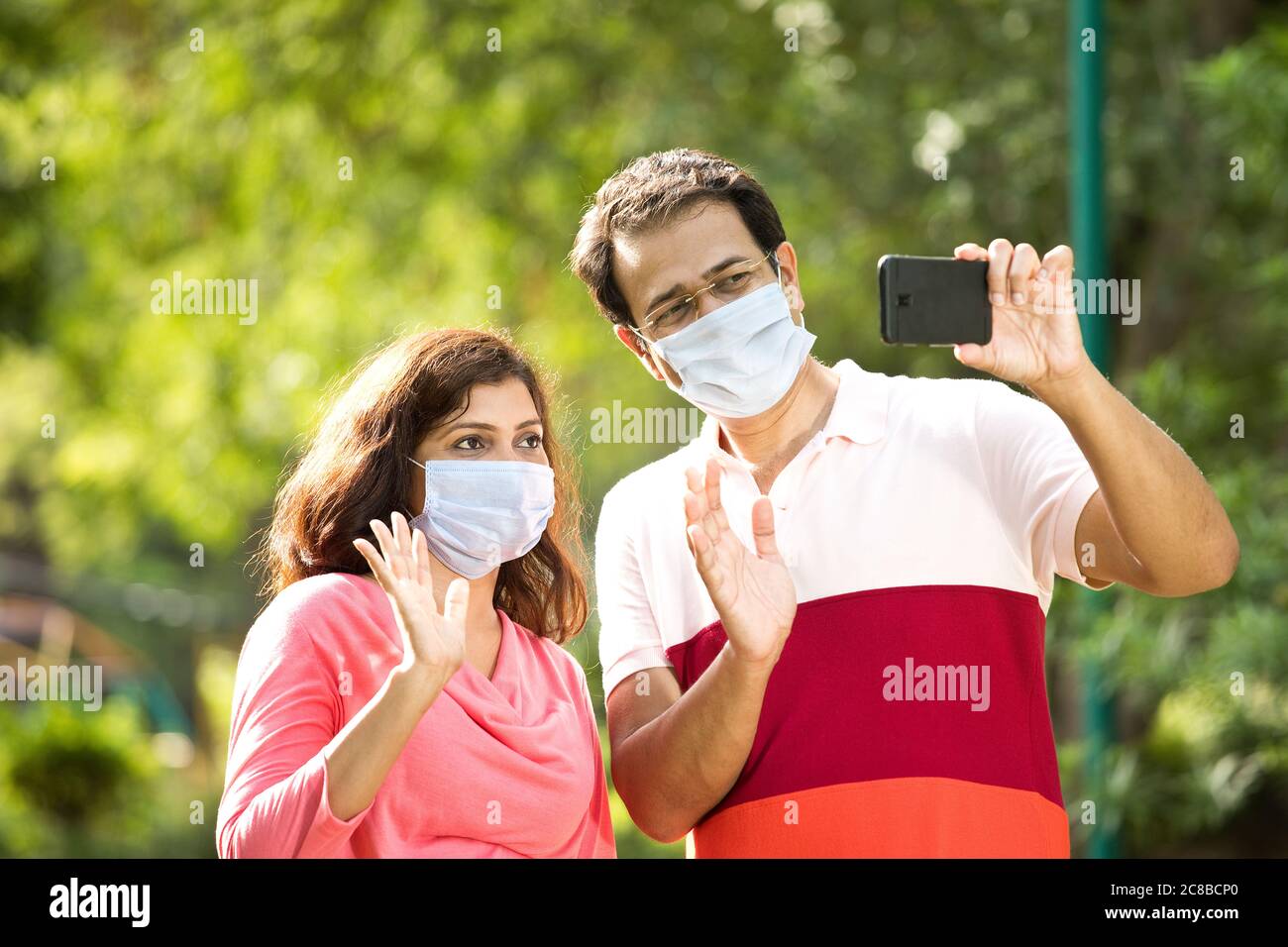 Couple using mobile phone for video call Stock Photo - Alamy