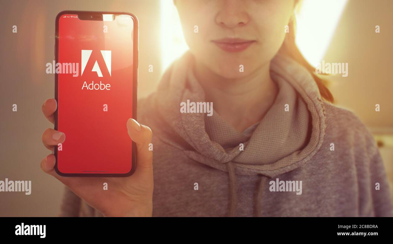KYIV, UKRAINE-JANUARY, 2020: Adobe on Smart Phone Screen. Young Girl ...