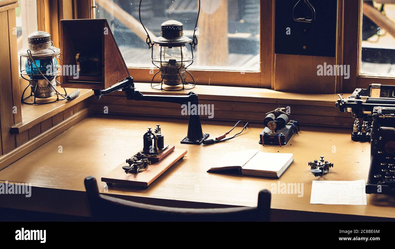 Various vintage mechanisms and notepad with blank pages placed on desk ...