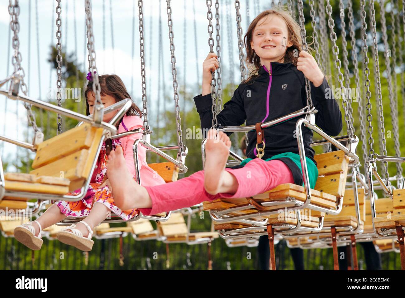 kids enjoying the ride on a carousel during a sunny afternoon at ...