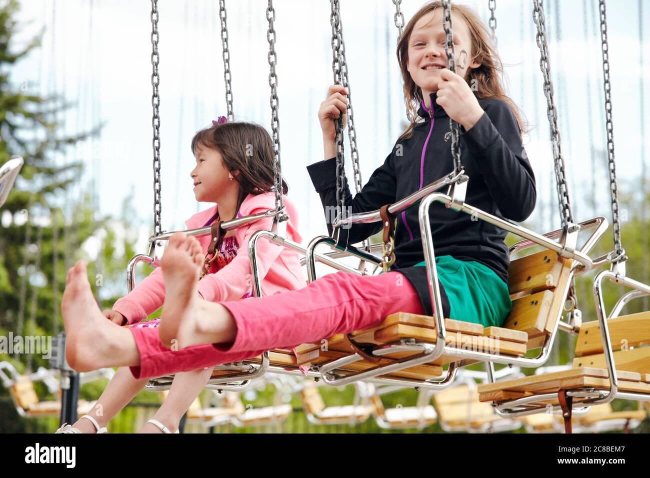 kids enjoying the ride on a carousel during a sunny afternoon at ...