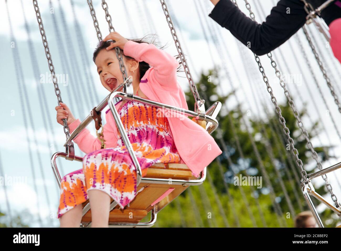 kids enjoying the ride on a carousel during a sunny afternoon at ...