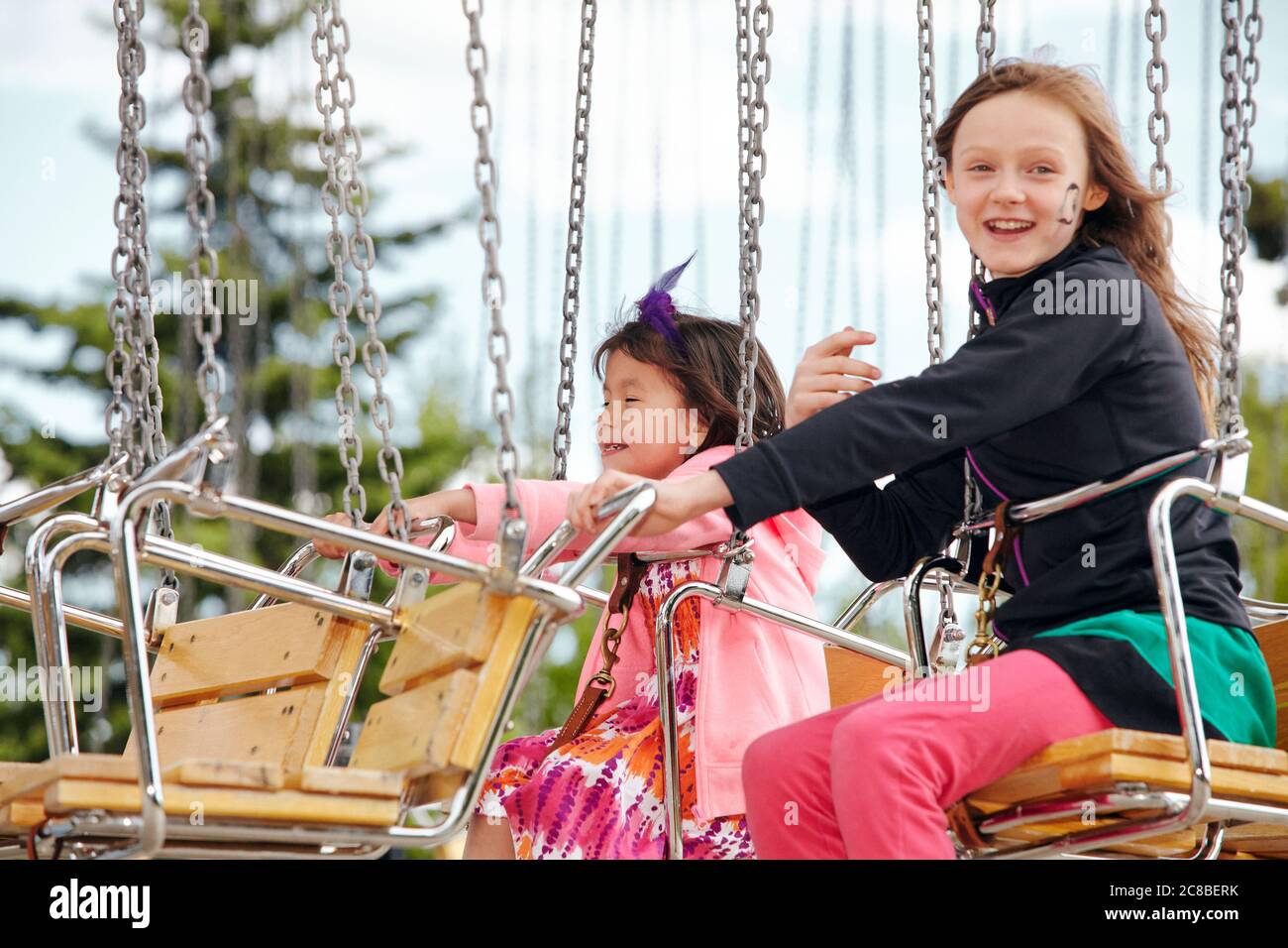 kids enjoying the ride on a carousel during a sunny afternoon at ...