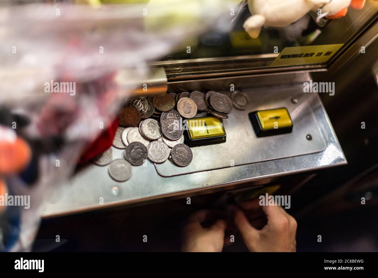 Coins and buttons on a coin machine Stock Photo - Alamy