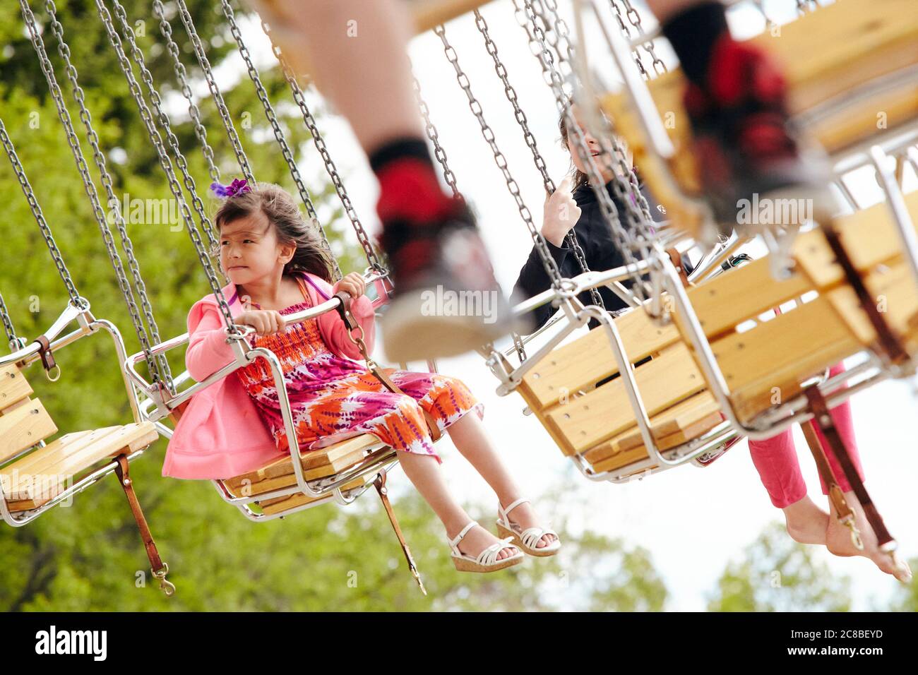 kids enjoying the ride on a carousel during a sunny afternoon at ...