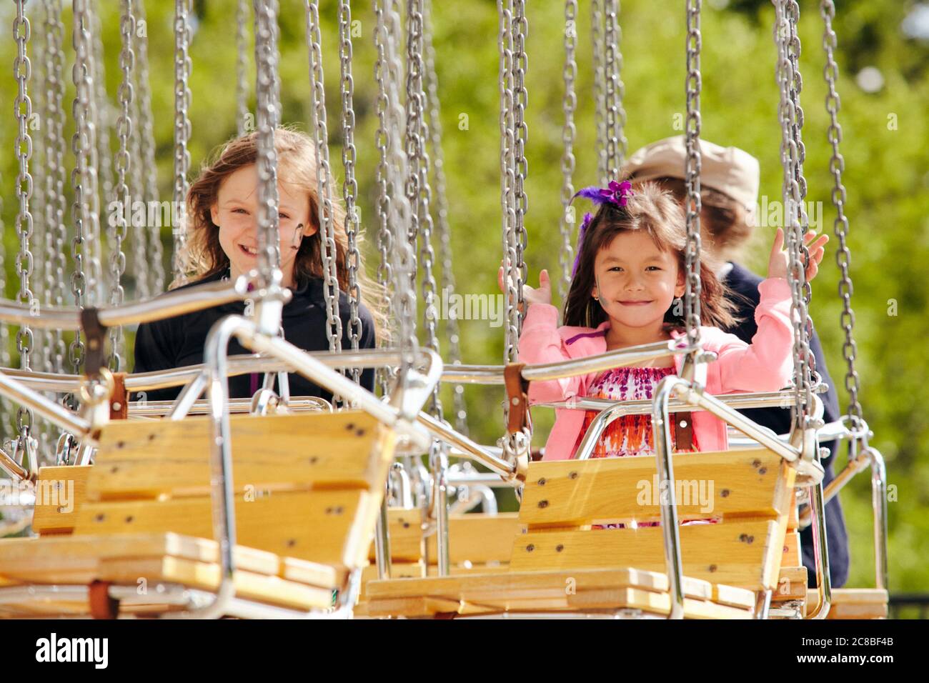 kids enjoying the ride on a carousel during a sunny afternoon at ...