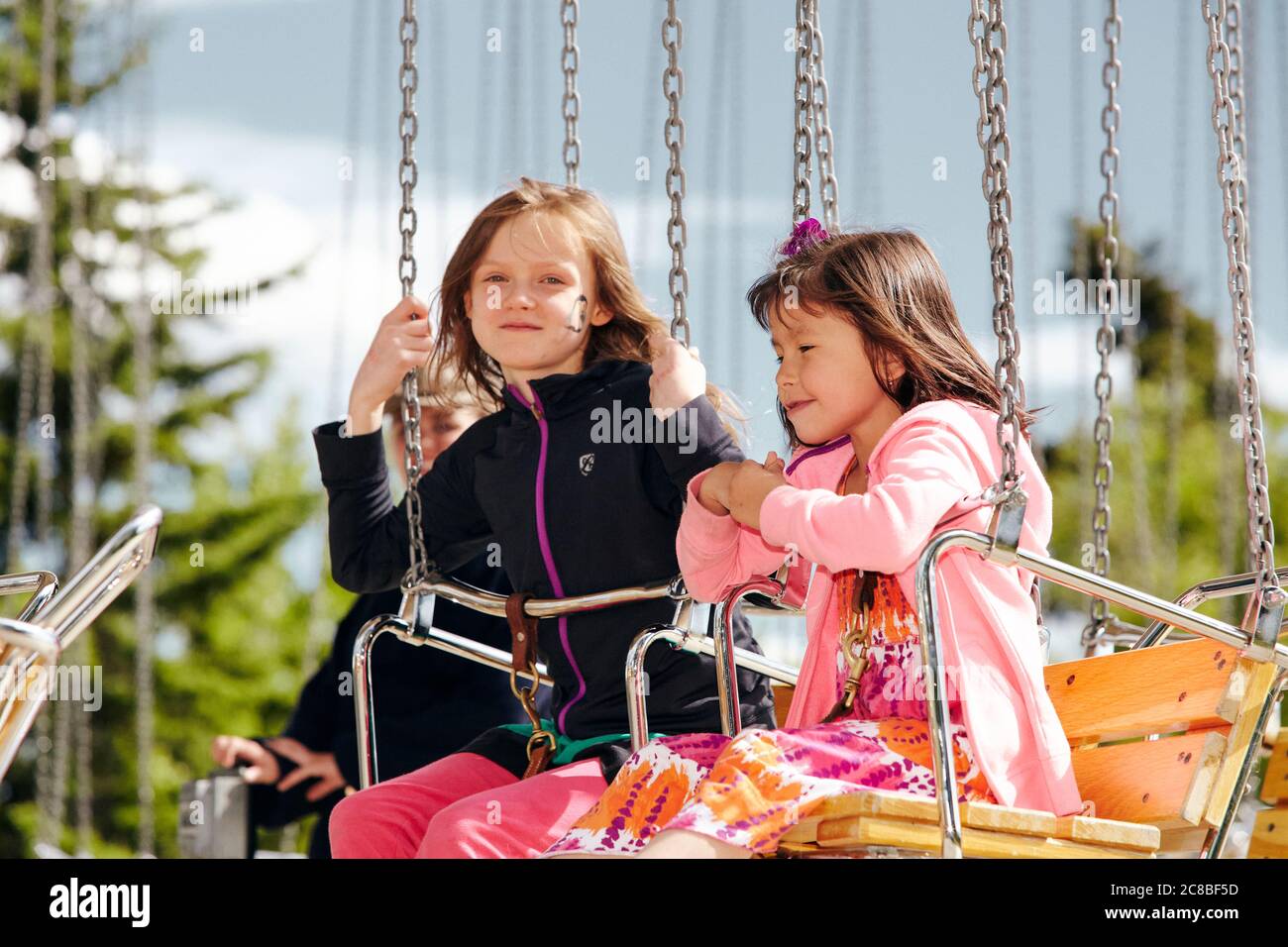 kids enjoying the ride on a carousel during a sunny afternoon at ...
