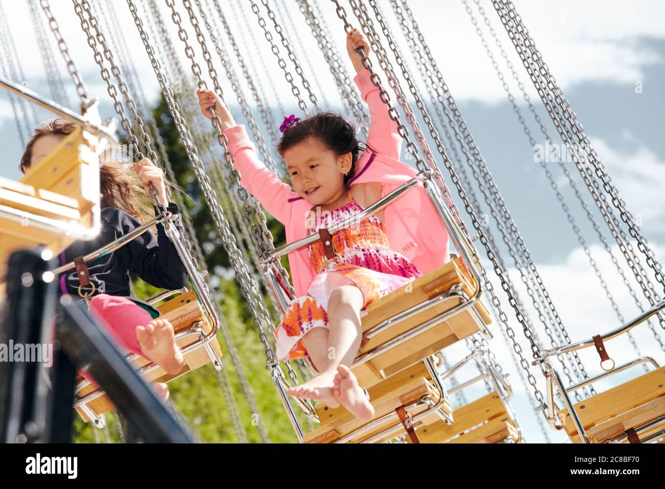kids enjoying the ride on a carousel during a sunny afternoon at ...