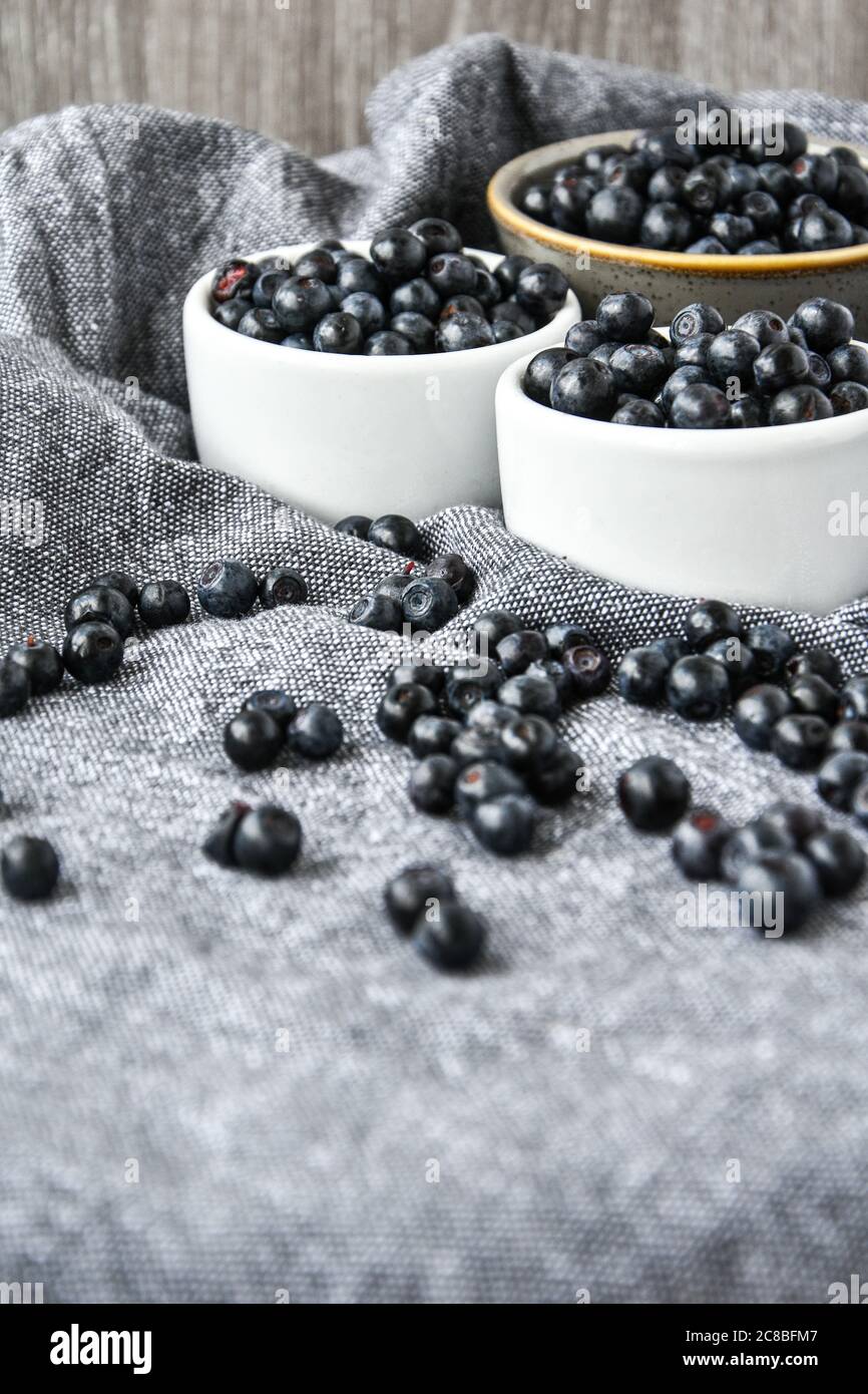 Small White Bowl of Organic Blueberries on Wooden Table with kitchen ...