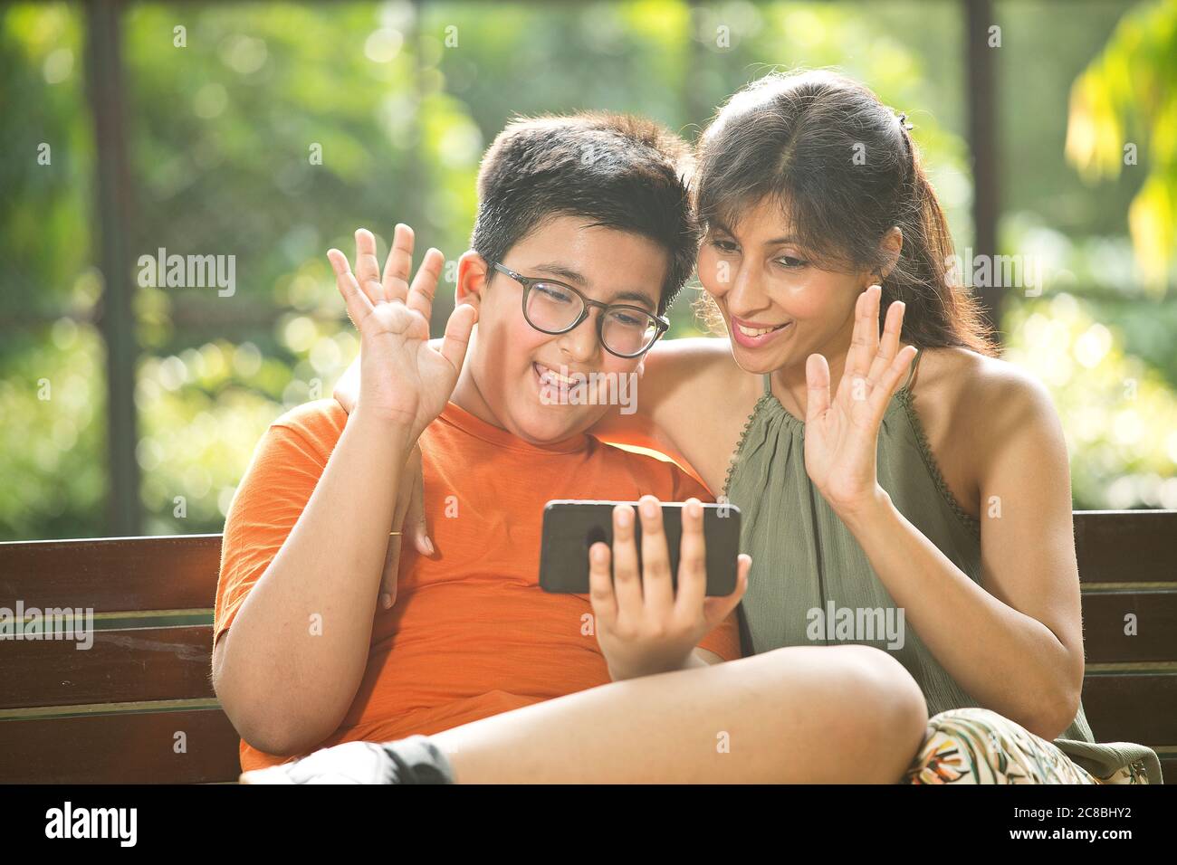 Mother and son using mobile phone for video call Stock Photo - Alamy