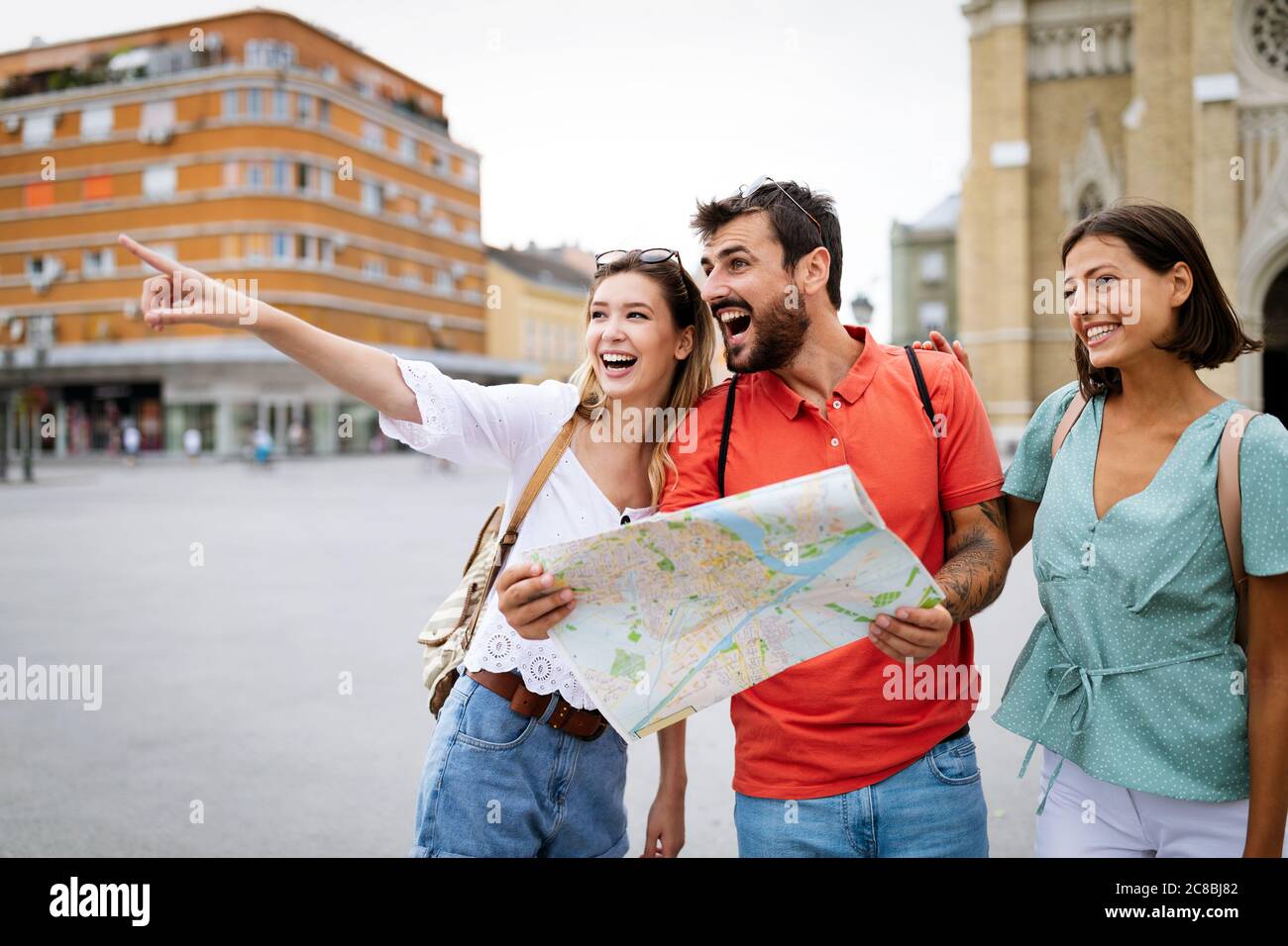 Holidays, travel, friends and tourism concept. Happy friends looking ...
