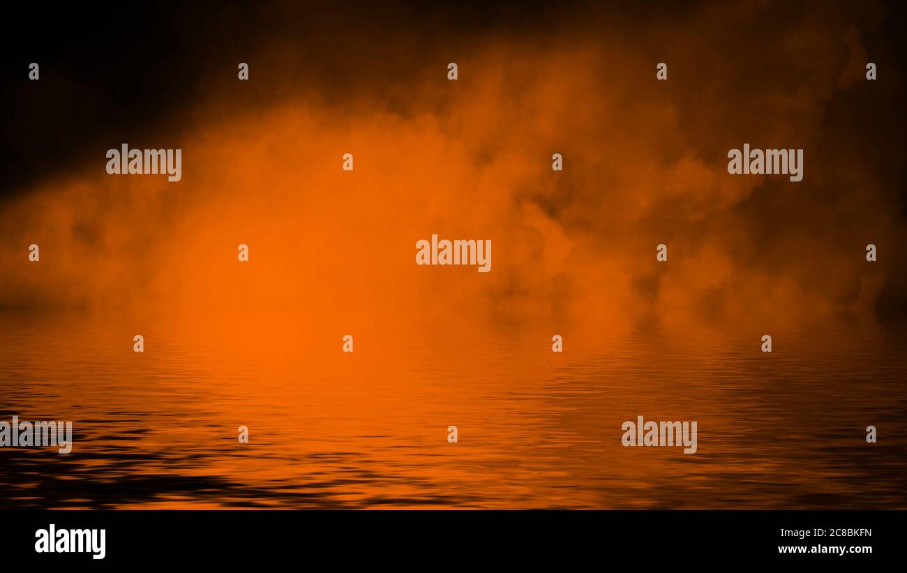 Abstract orange smoke with reflection in water .Lighting spotlighting ...