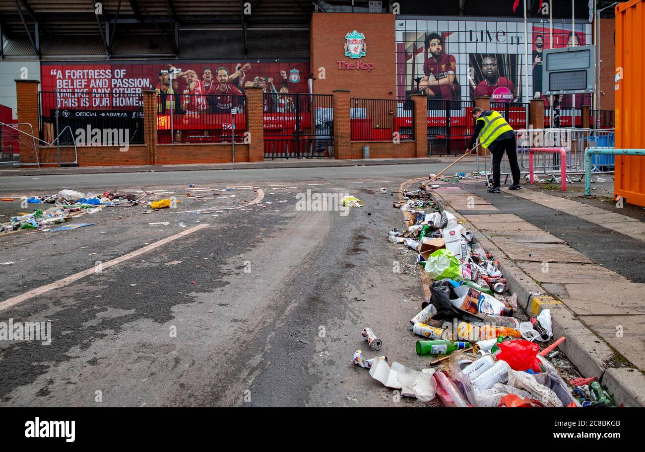 Rubbish is cleaned up outside Anfield following celebrations last night ...