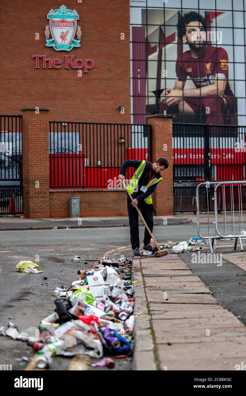 Rubbish is cleaned up outside Anfield following celebrations last night ...