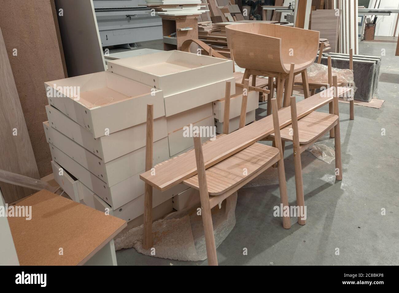 Manufacture of wooden furniture in the factory. Incomplete process of ...