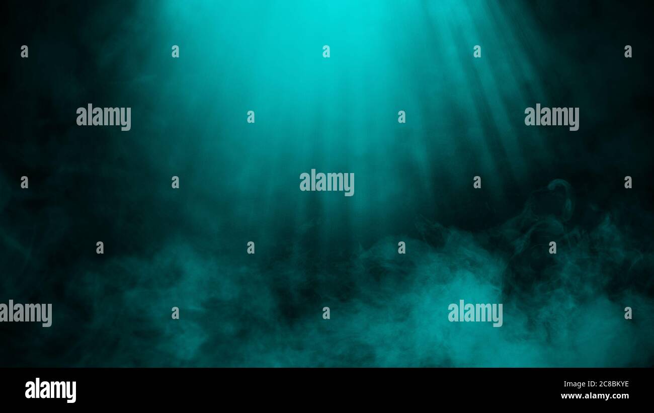 Abstract blue spotlight with smoke mist fog on a black background ...