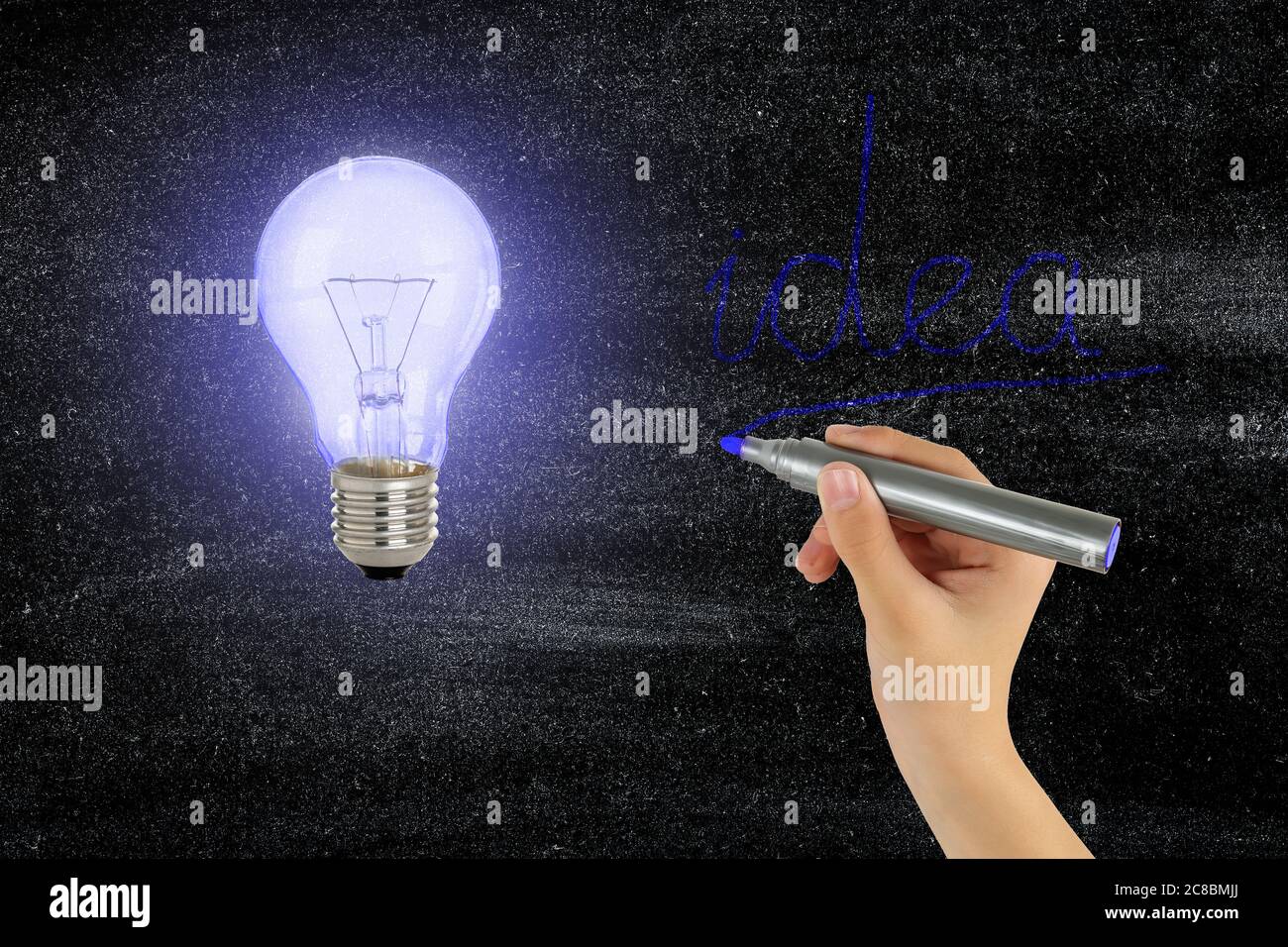 light bulb and hand writing idea on black board, idea concept Stock ...