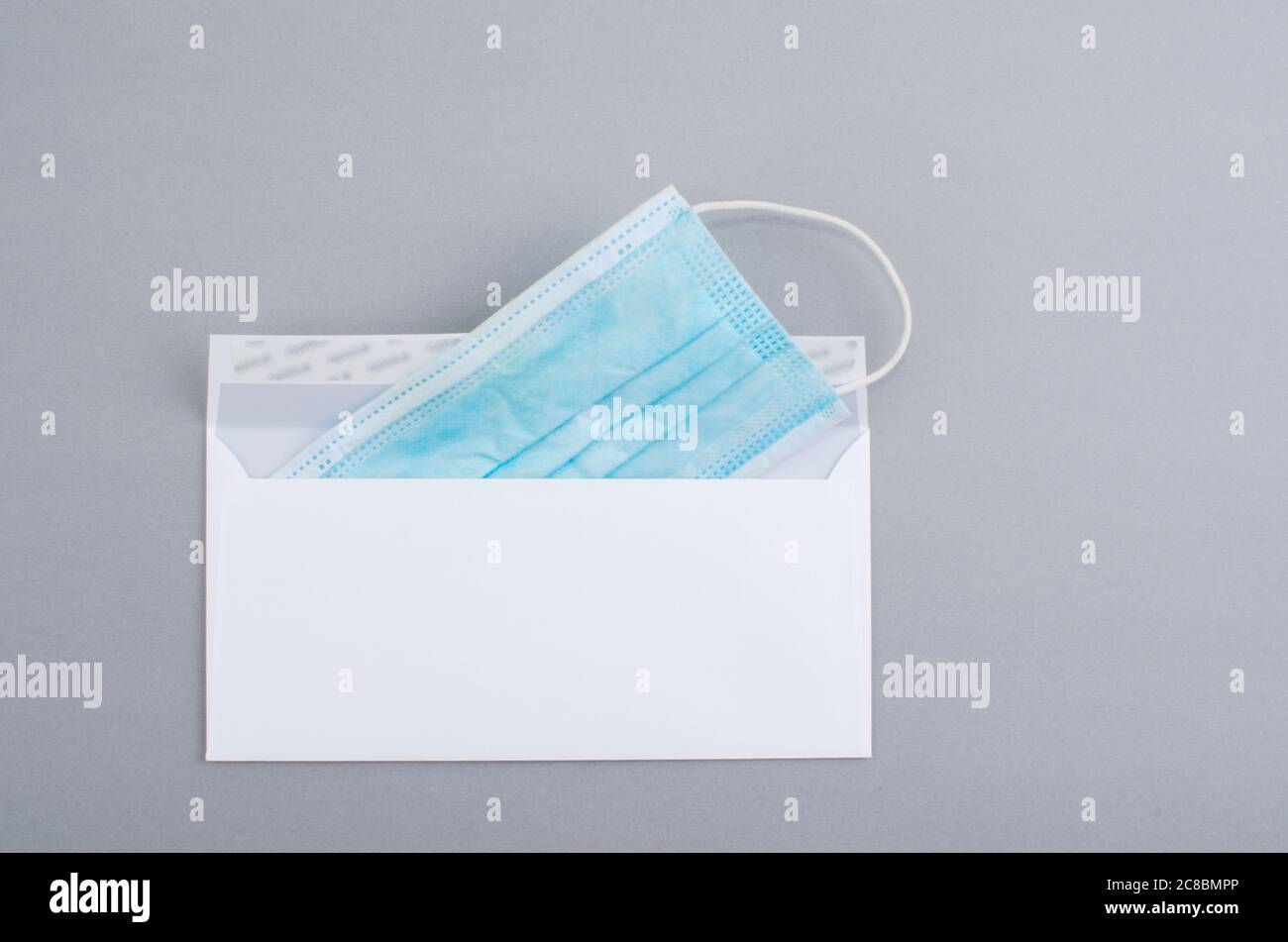 Surgical mask inside a white envelope in the gray background Stock ...