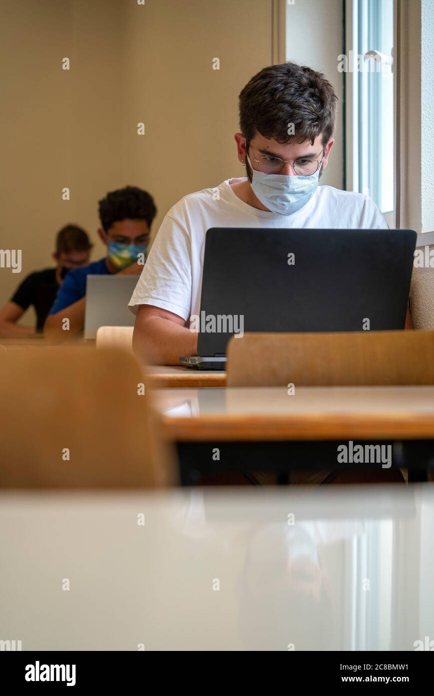 Students wearing face masks in class during the novel coronavirus COVID ...