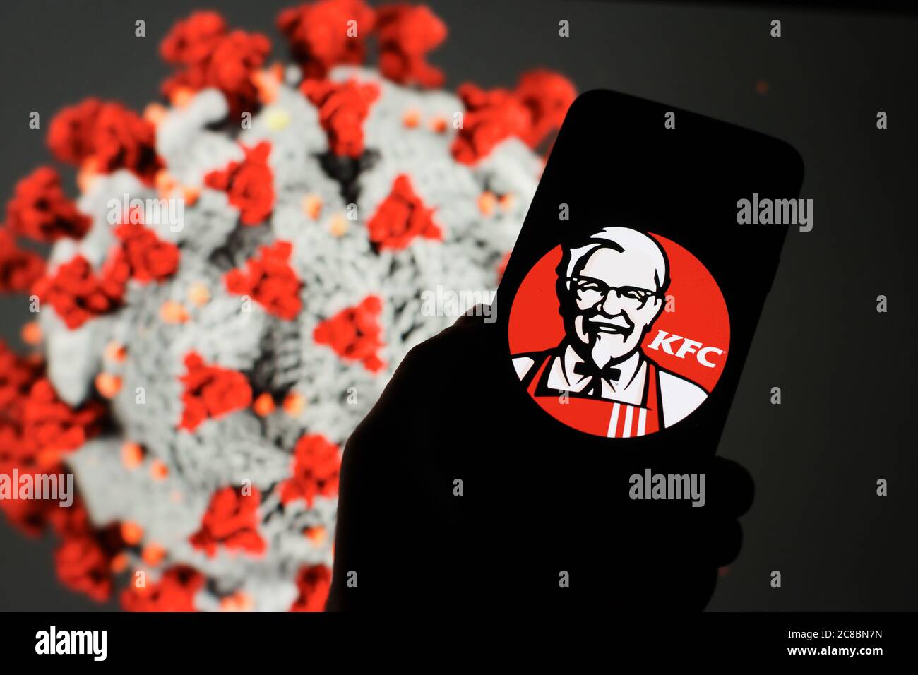 In this photo illustration a KFC logo seen displayed on a smartphone ...